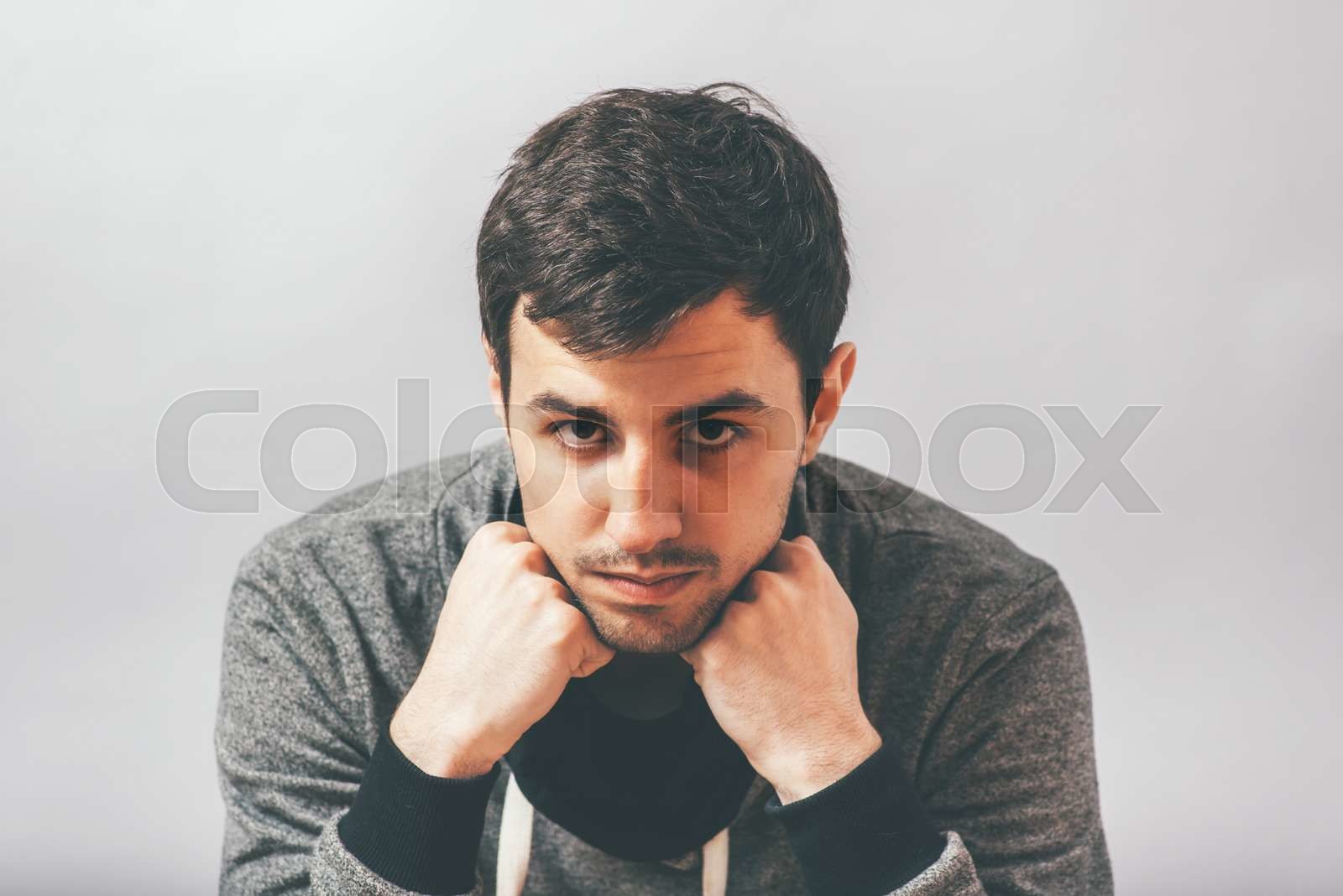 guy props chin in his hand | Stock image | Colourbox