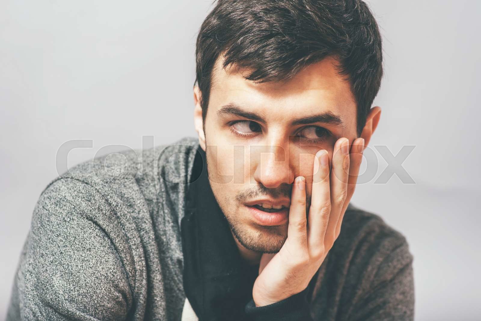 guy props chin in his hand | Stock image | Colourbox