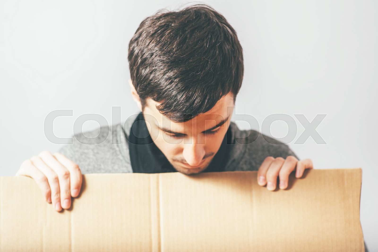 guy with the cardboard in the hands of | Stock image | Colourbox