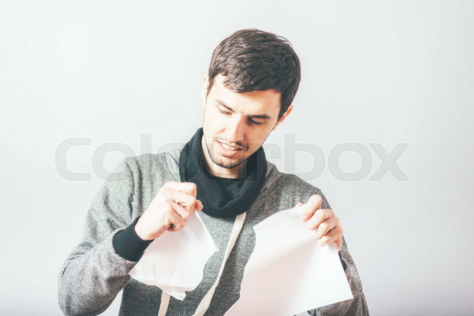 guy tears the paper | Stock image | Colourbox