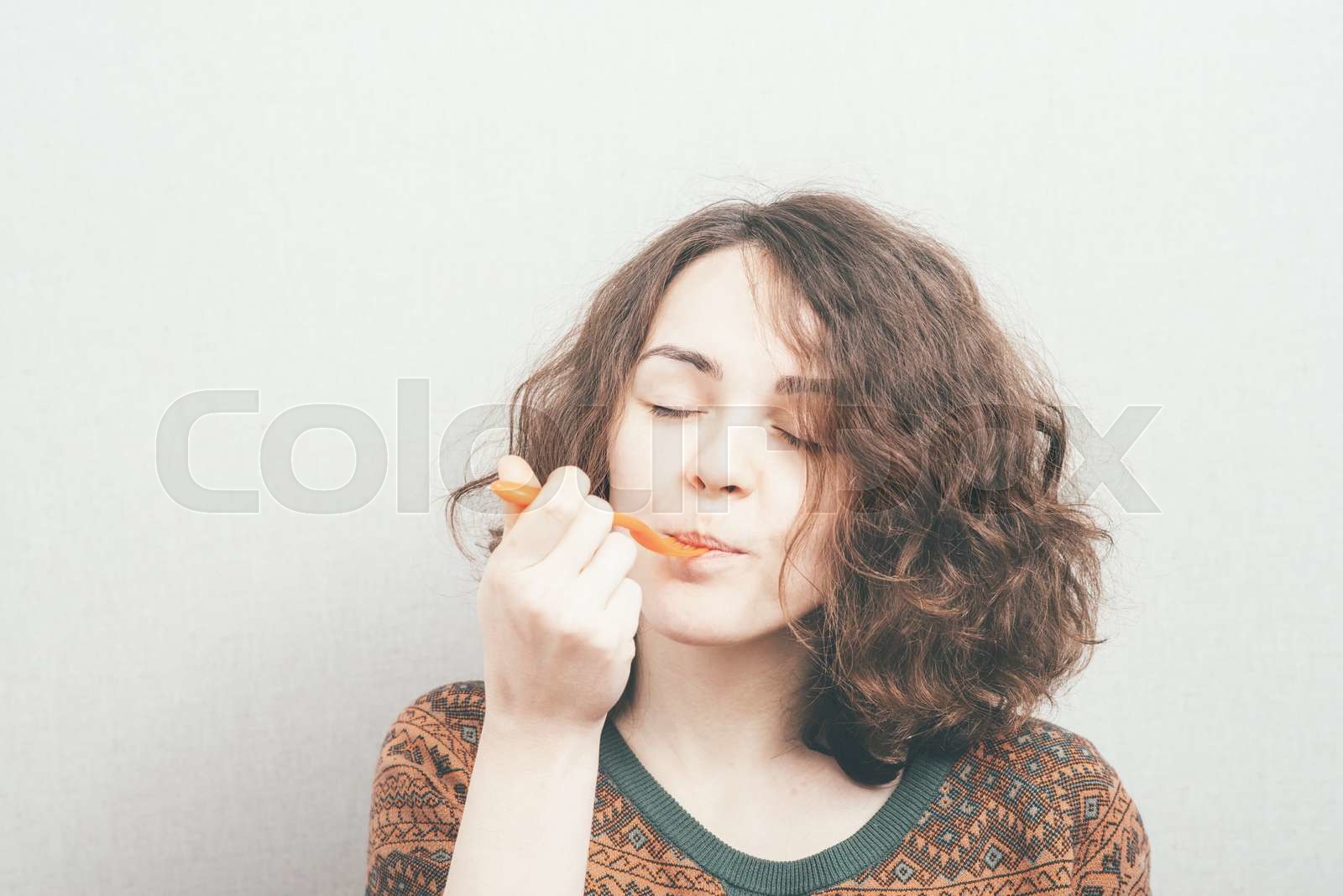 girl eats with a fork | Stock image | Colourbox