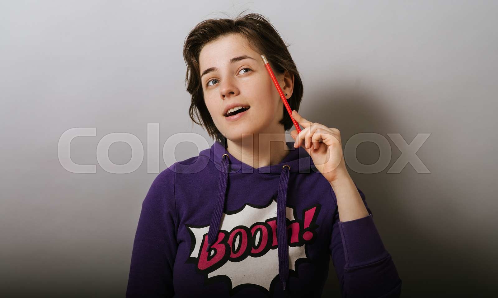 Girl thinking with a pencil | Stock image | Colourbox