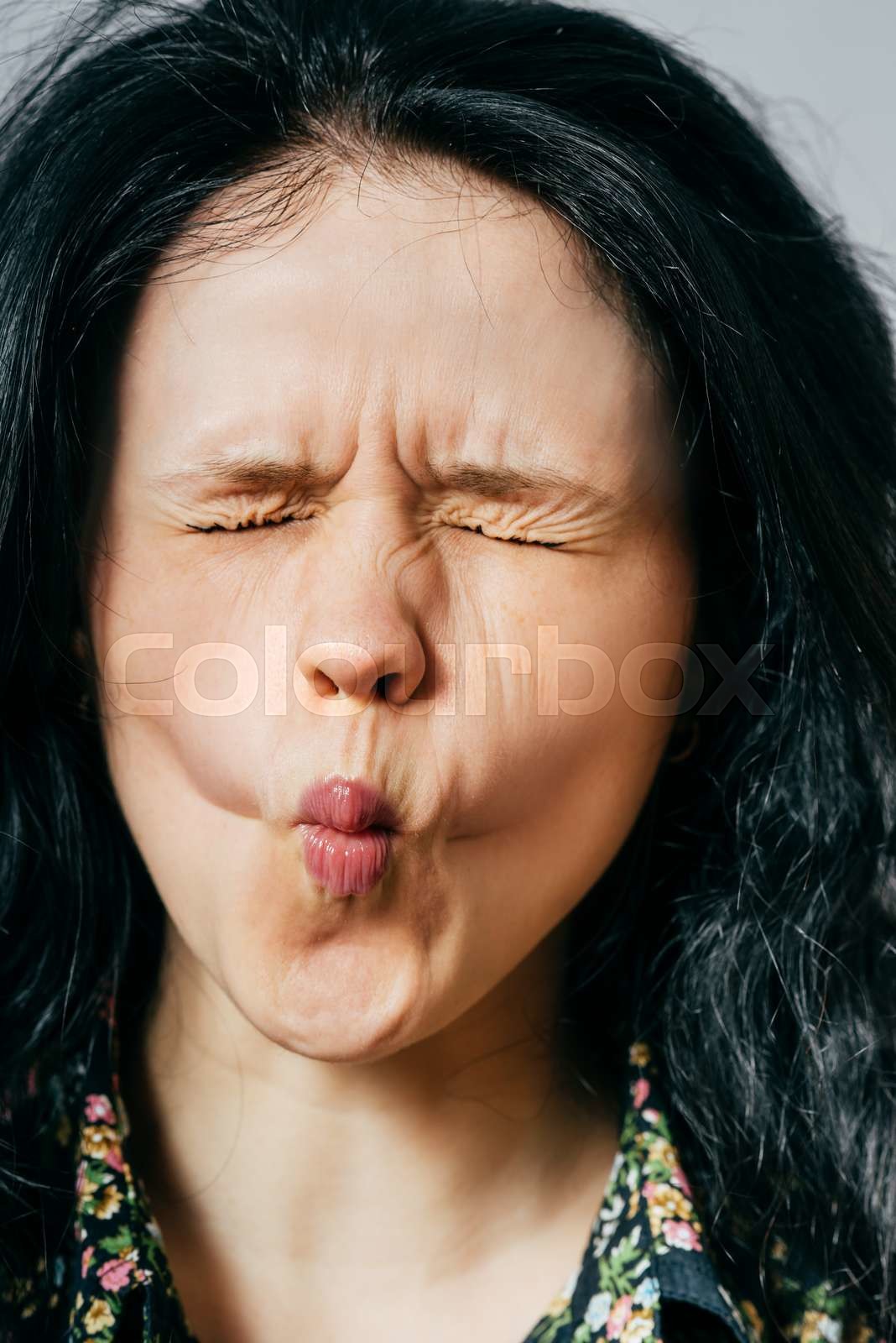 headshot portrait of beautiful women sucking in cheeks | Stock image ...
