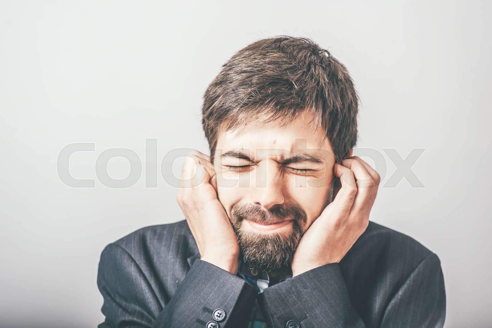 man covers his ears | Stock image | Colourbox