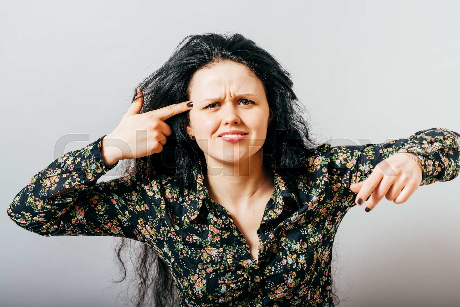 girl points to the head | Stock image | Colourbox