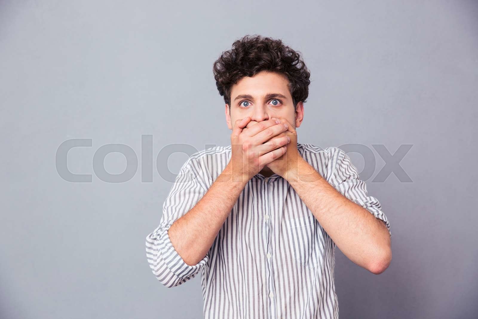 Man covering his mouth | Stock image | Colourbox