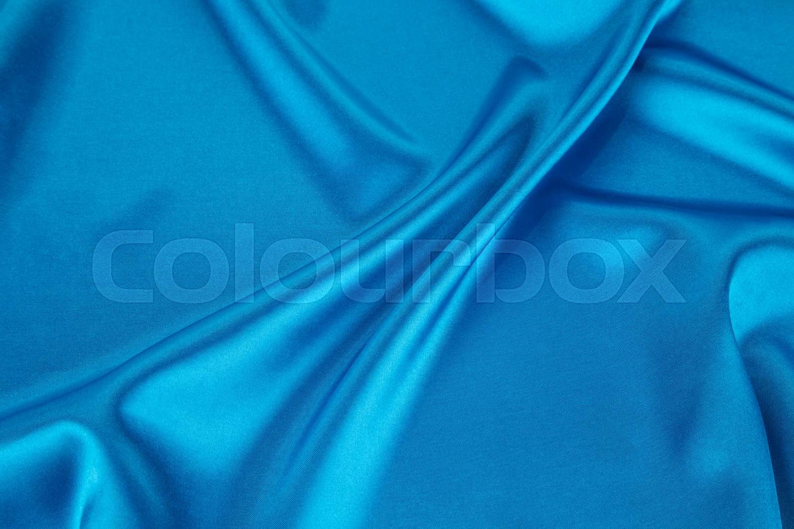 Soft folds of blue silk cloth. | Stock image | Colourbox