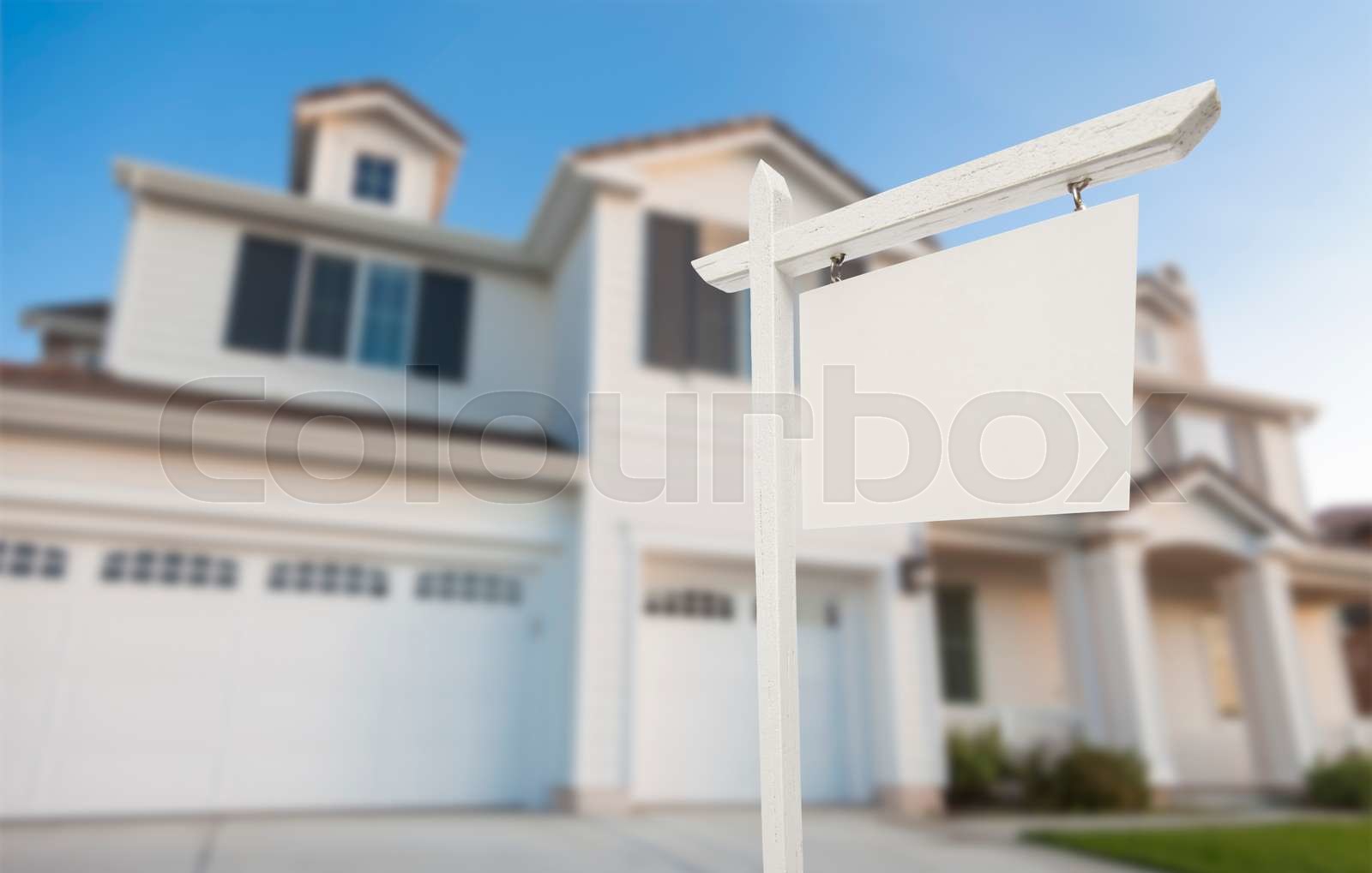 Blank Real Estate Sign in Front of New House | Stock image | Colourbox