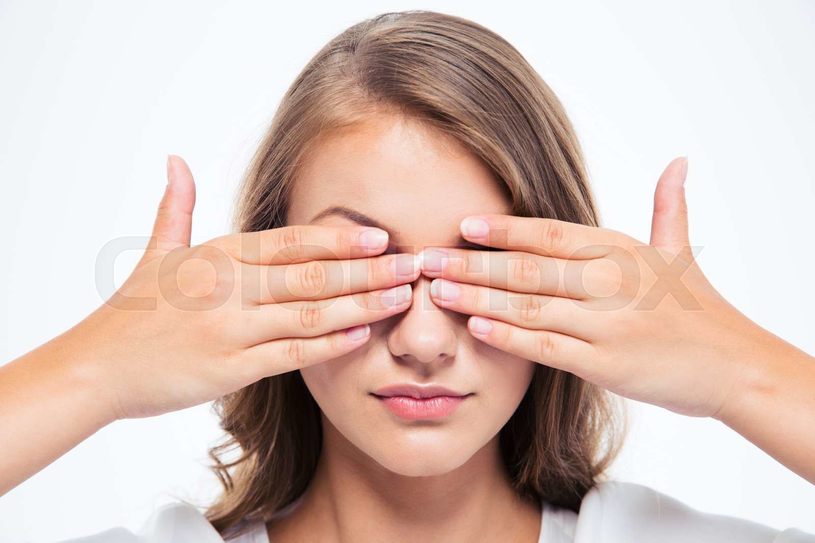 Young woman covering her eyes | Stock image | Colourbox