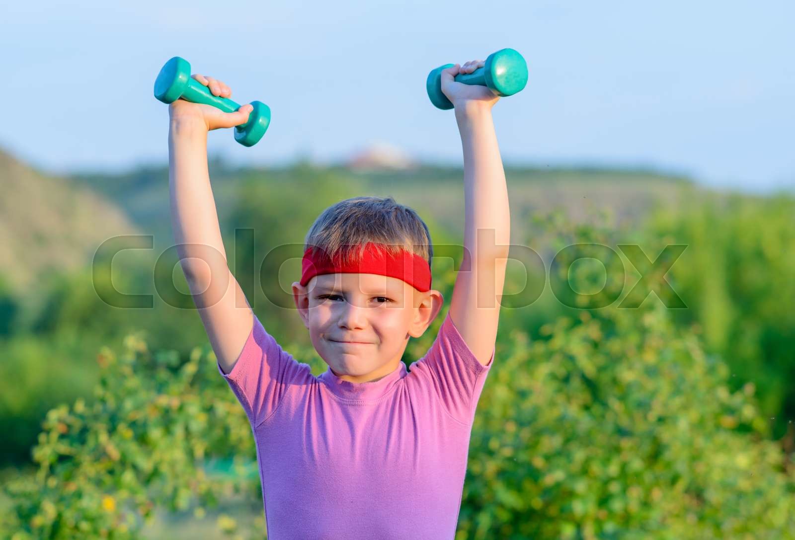 Strong Boy Lifting Two Small Dumbbells | Stock image | Colourbox