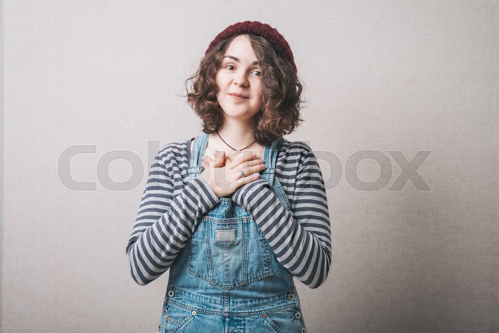Joyful woman holding hands on his chest | Stock image | Colourbox