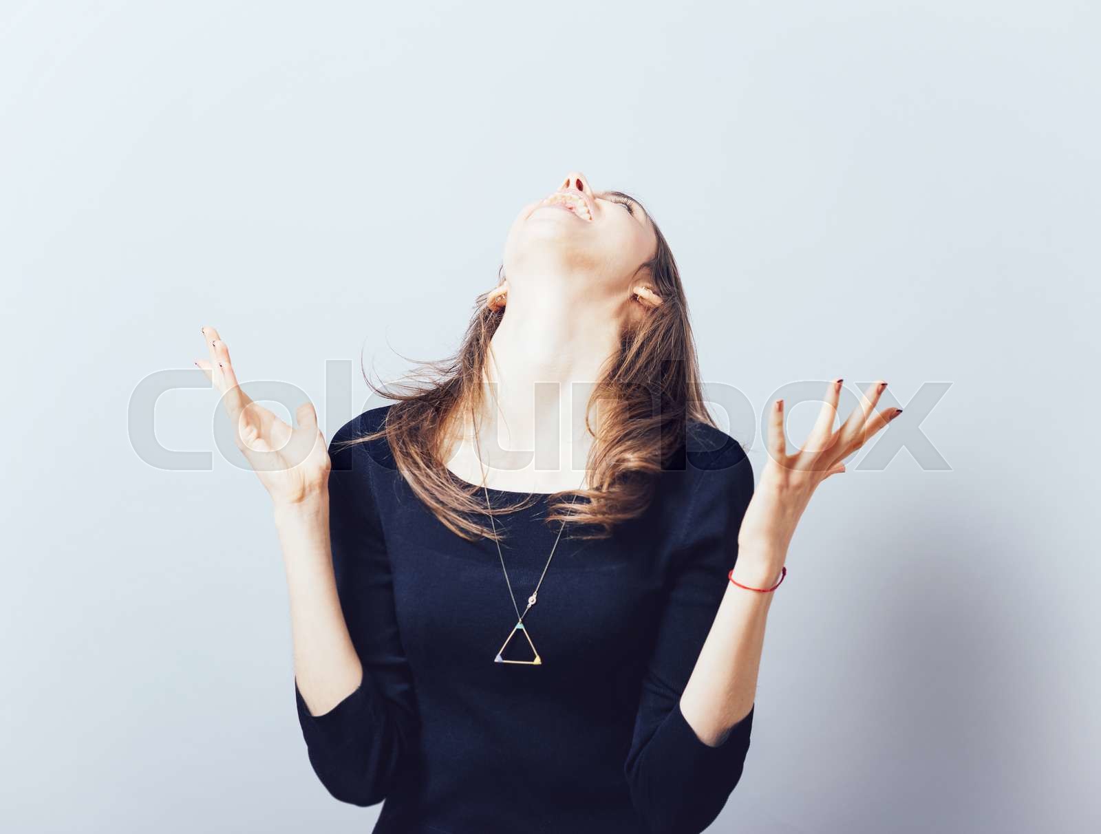 Excited young woman with fists up | Stock image | Colourbox