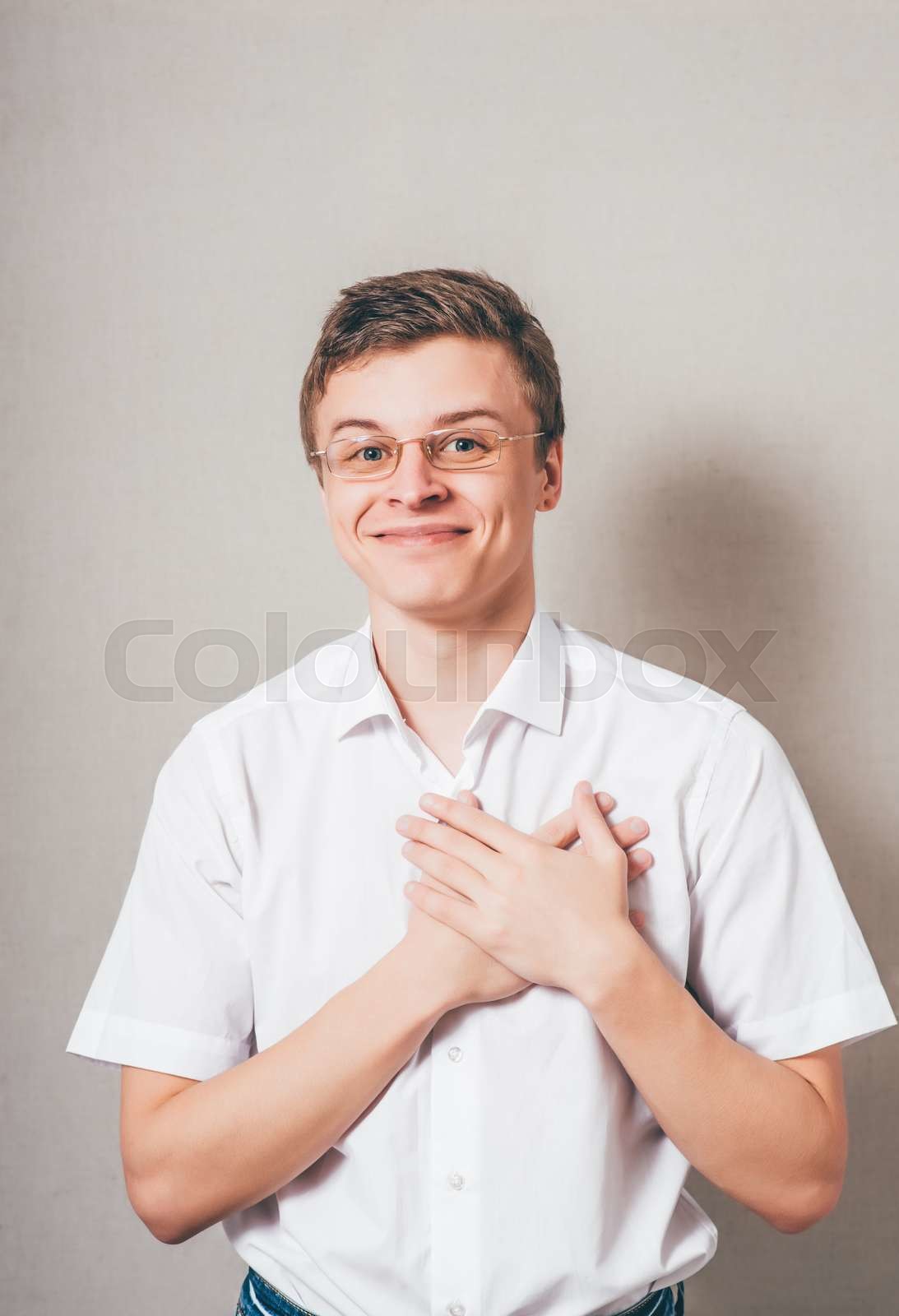 Handsome male resting hands on his chest | Stock image | Colourbox