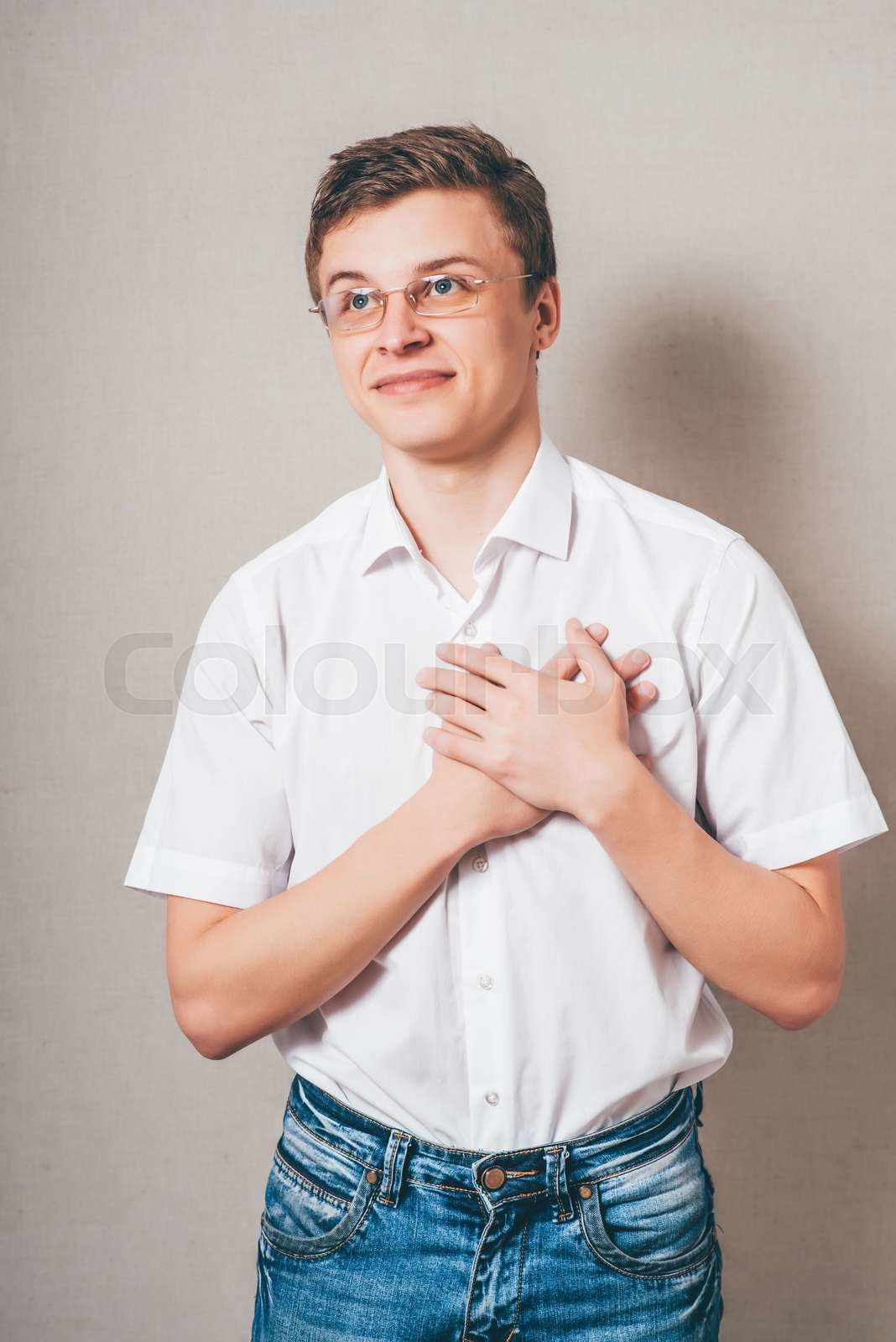Handsome male resting hands on his chest | Stock image | Colourbox