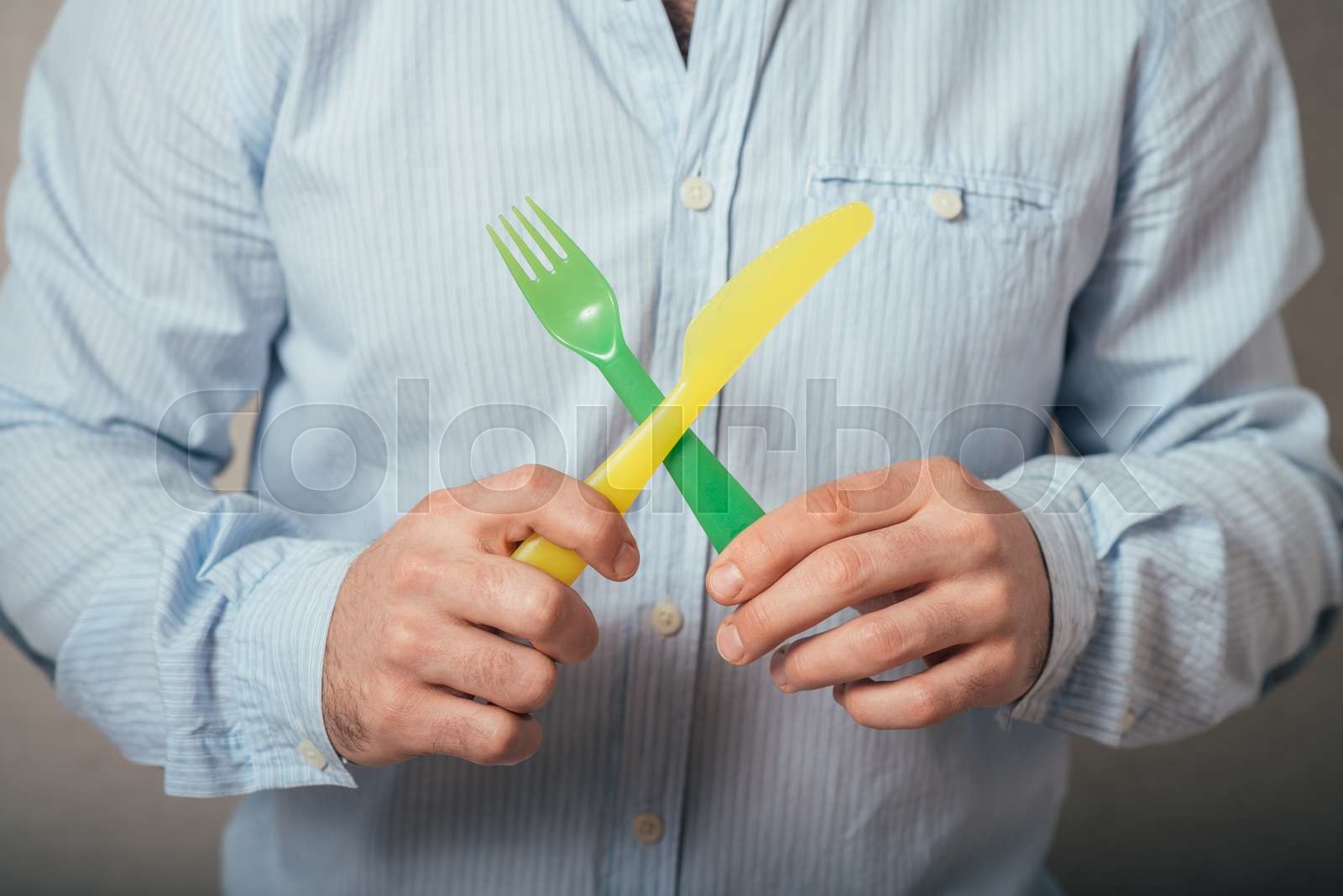 Young happy man holding a fork and a knife | Stock image | Colourbox
