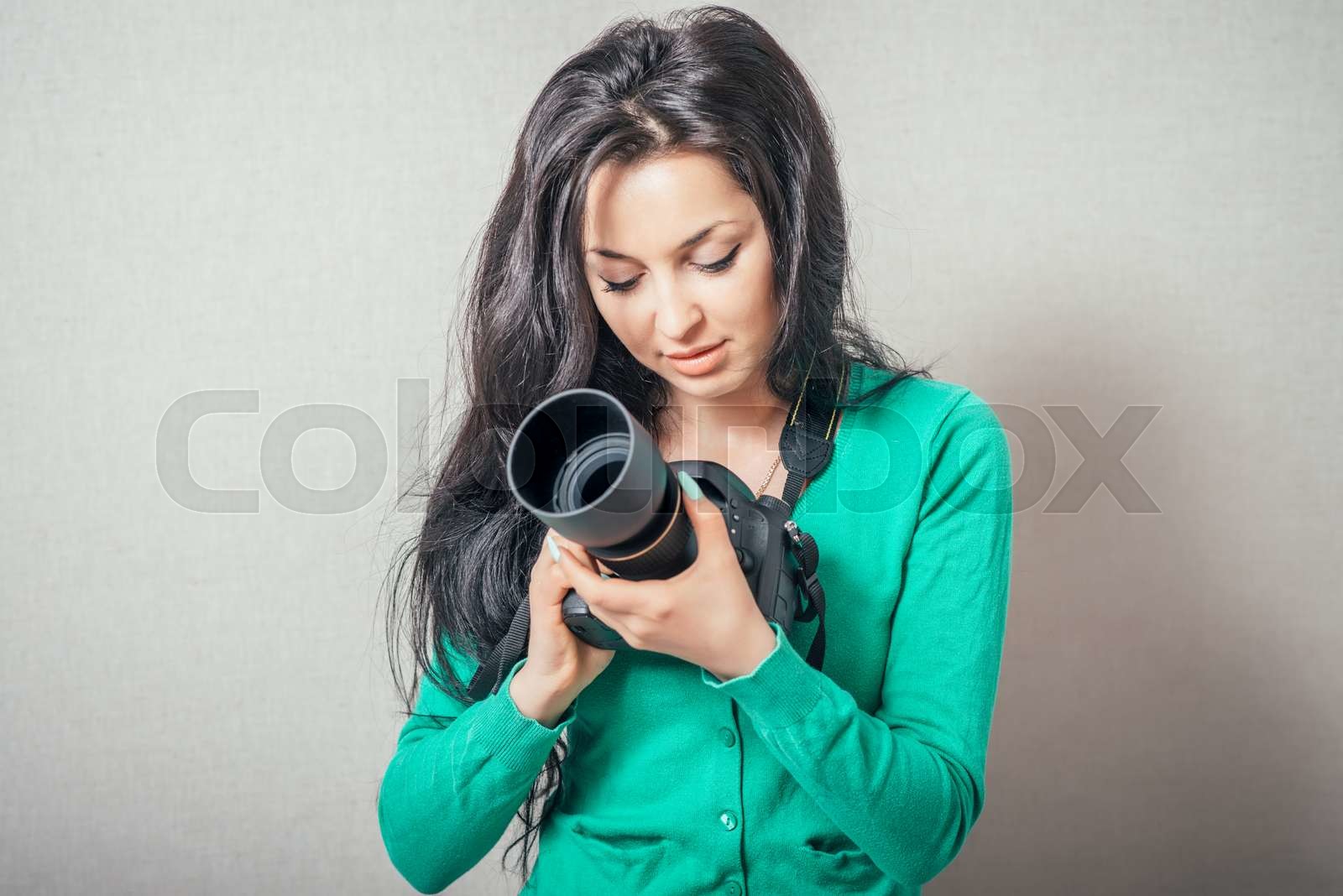 Female photograph holding a camera | Stock image | Colourbox