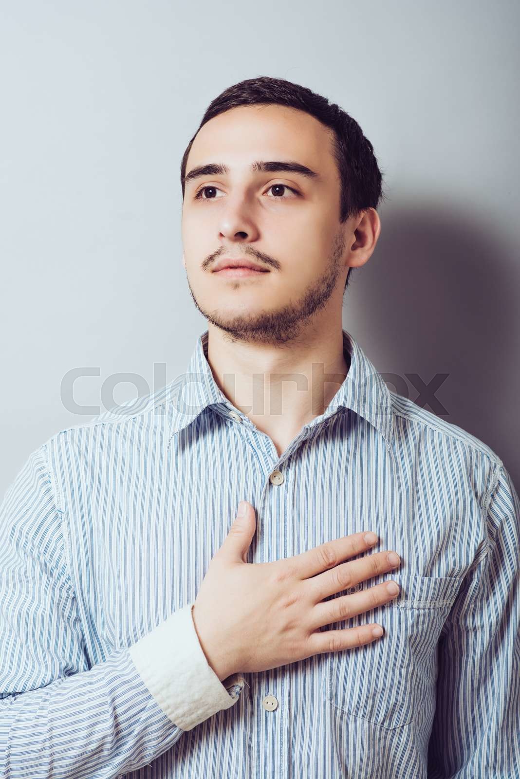 Handsome male resting hands on his chest | Stock image | Colourbox