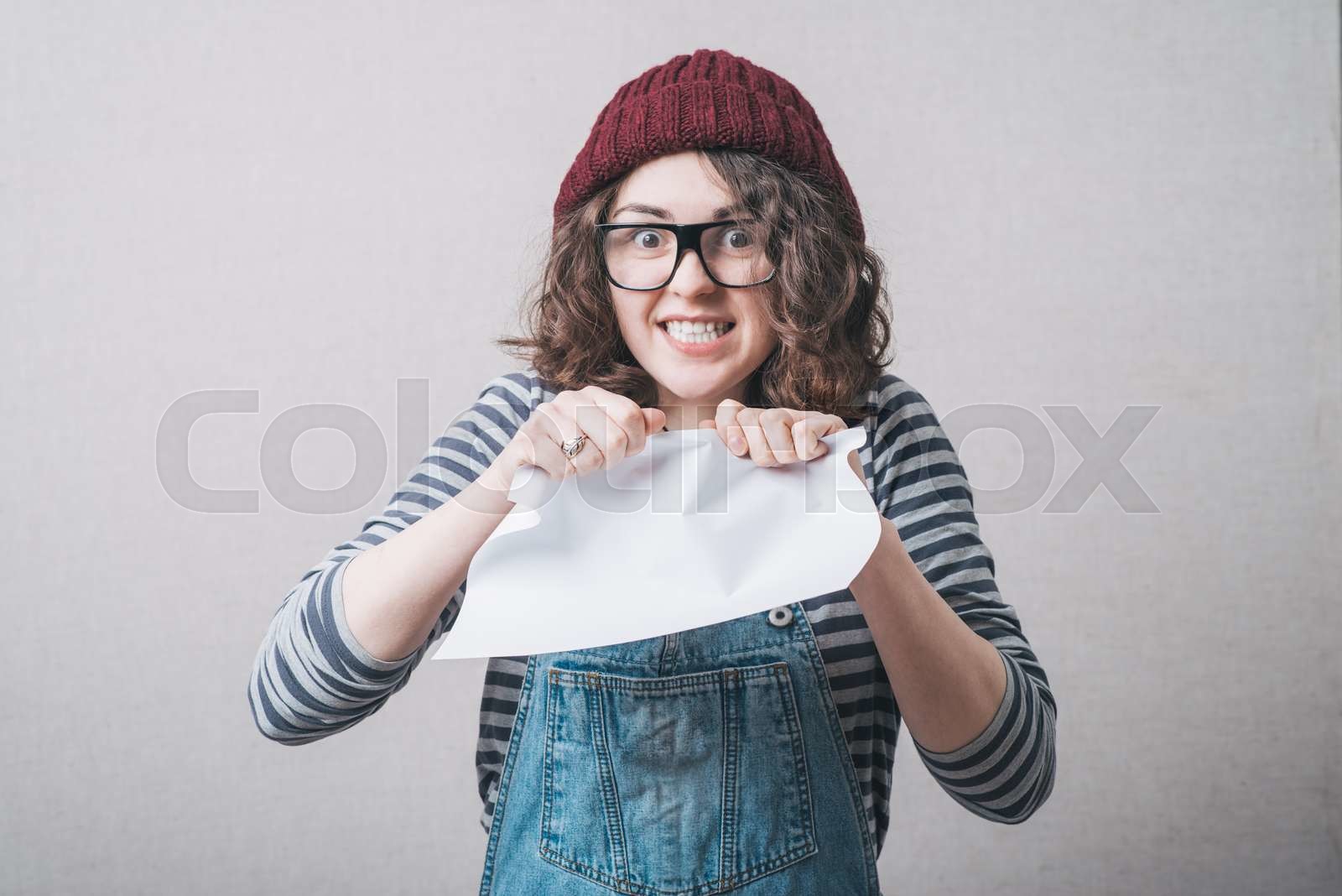 girl tearing the paper into small pieces | Stock image | Colourbox