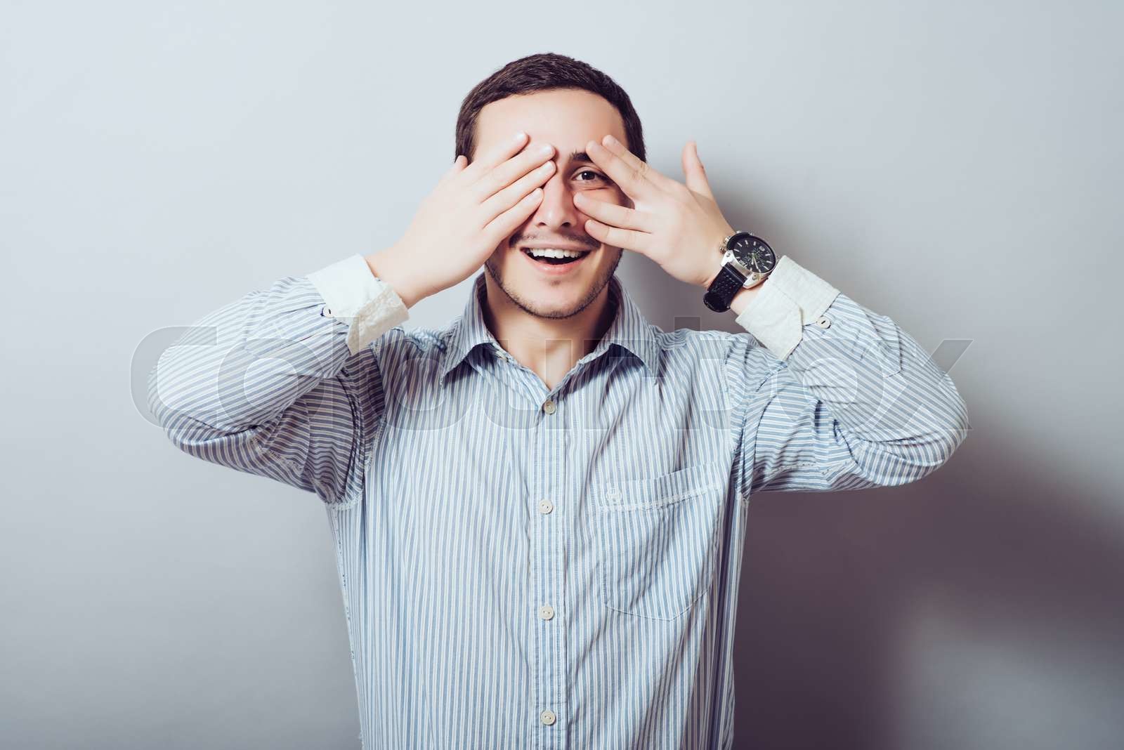 Watch Through his Fingers. | Stock image | Colourbox
