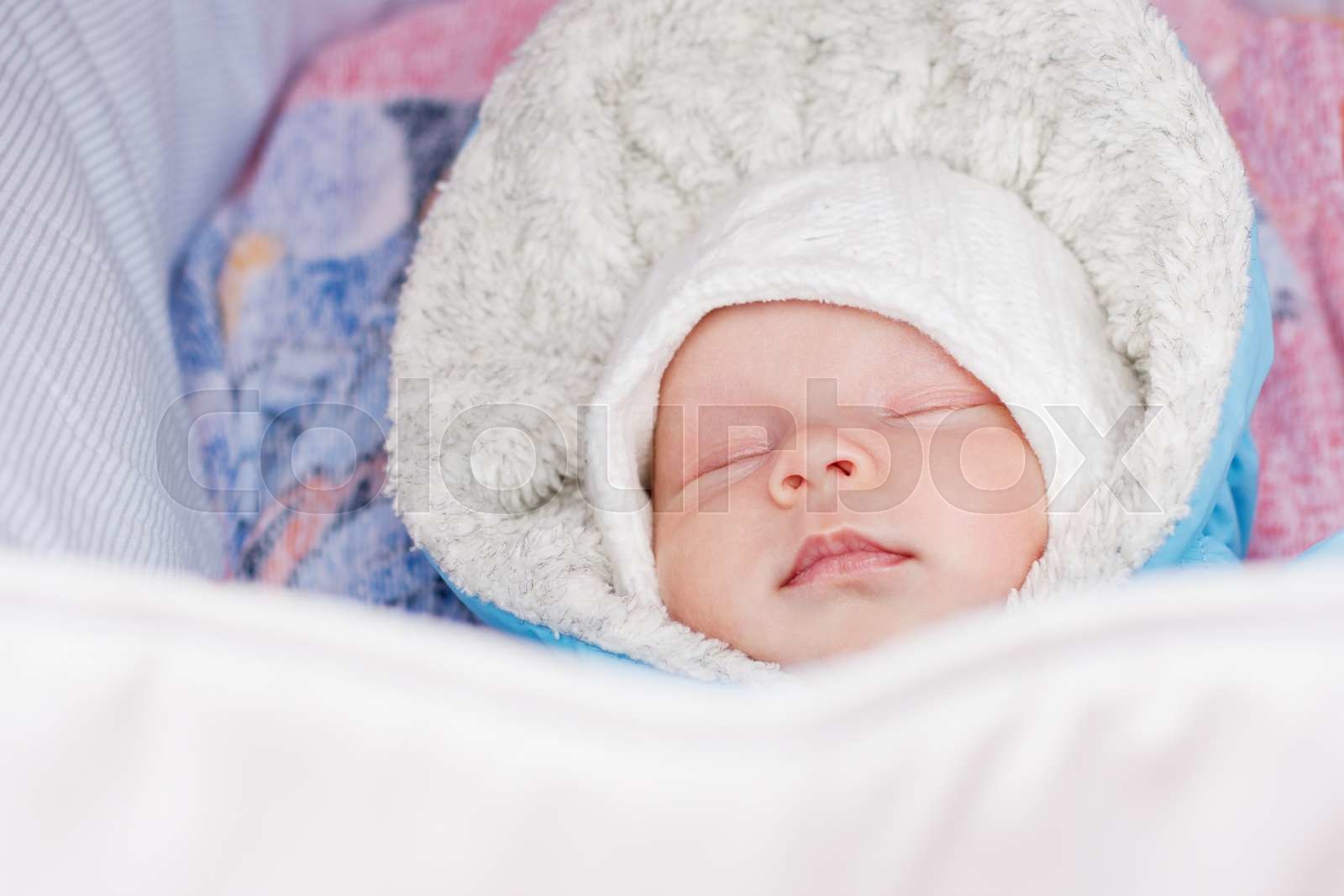newborn baby sleeping in a stroller | Stock image | Colourbox