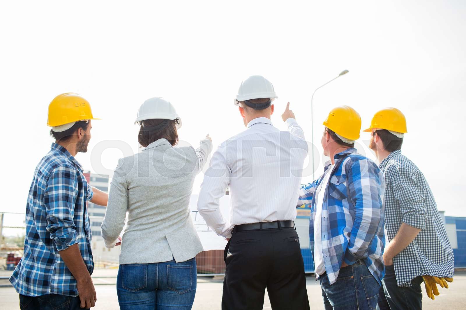 group of builders and architects at building site | Stock image | Colourbox