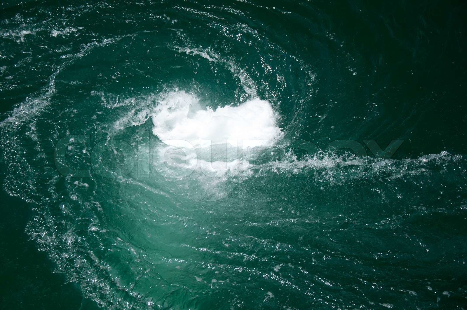A green water vortex that funnels below the surface. | Stock image ...