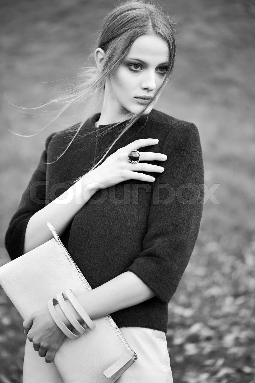 Fashion model with clutch poses outdoors | Stock image | Colourbox