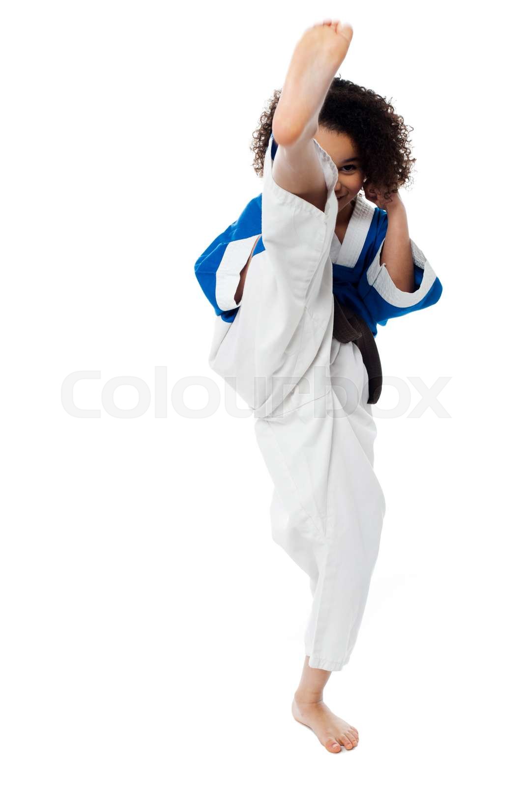 Karate girl kick a leg | Stock image | Colourbox