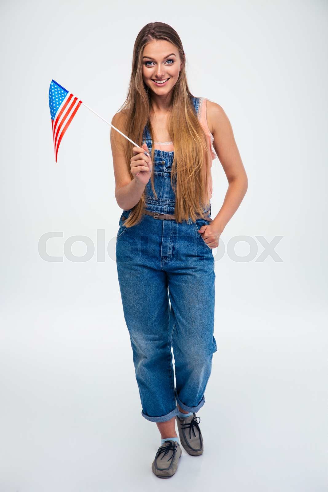 Smiling woman holding USA flag | Stock image | Colourbox