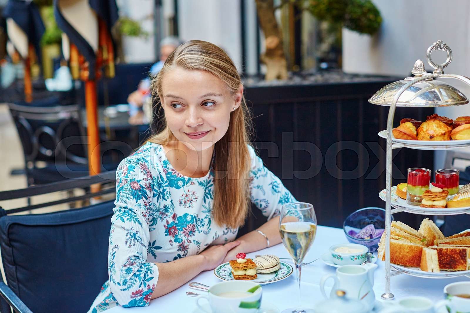 Beautiful young woman enjoying afternoon tea | Stock image | Colourbox