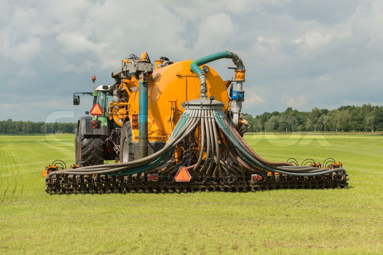 Injecting of liquid manure with tractor and yellow vulture spreader ...