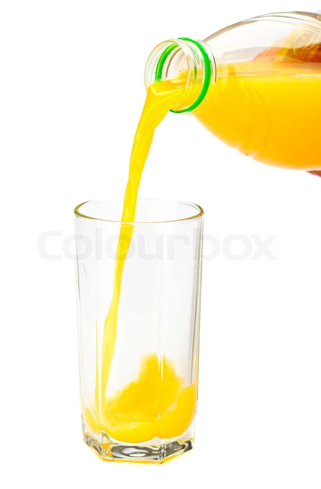 Orange juice pouring into glass on white | Stock image | Colourbox