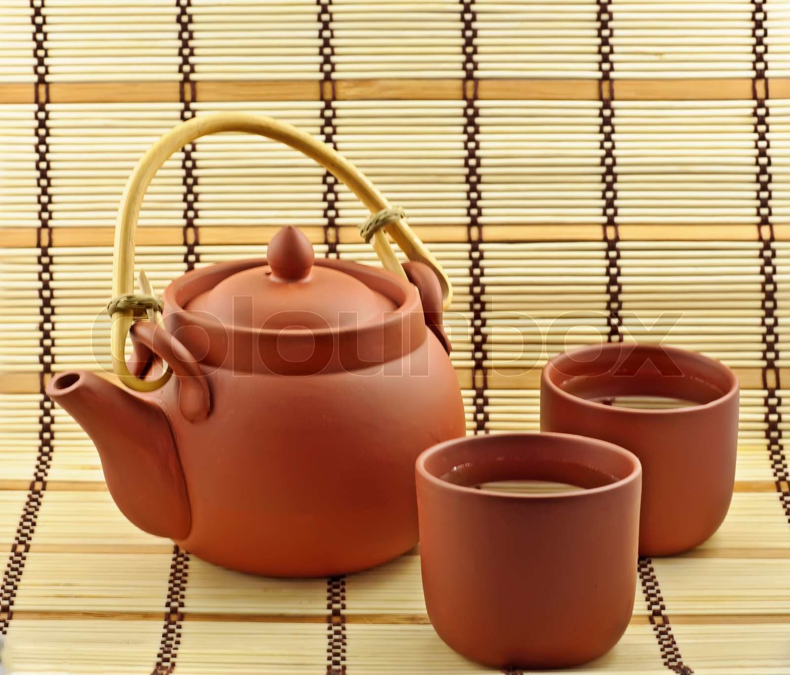 Clay set from two cups and teapot with green tea | Stock image | Colourbox