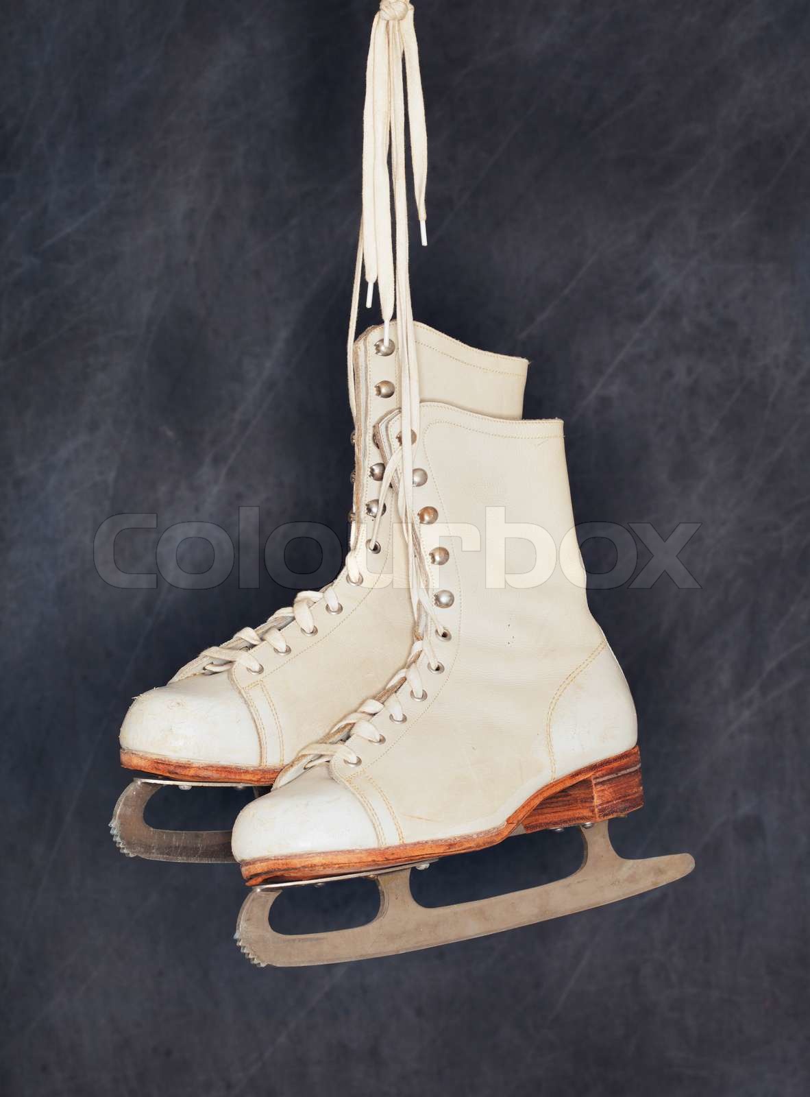 Old womens figure skates hanging from their laces | Stock image | Colourbox