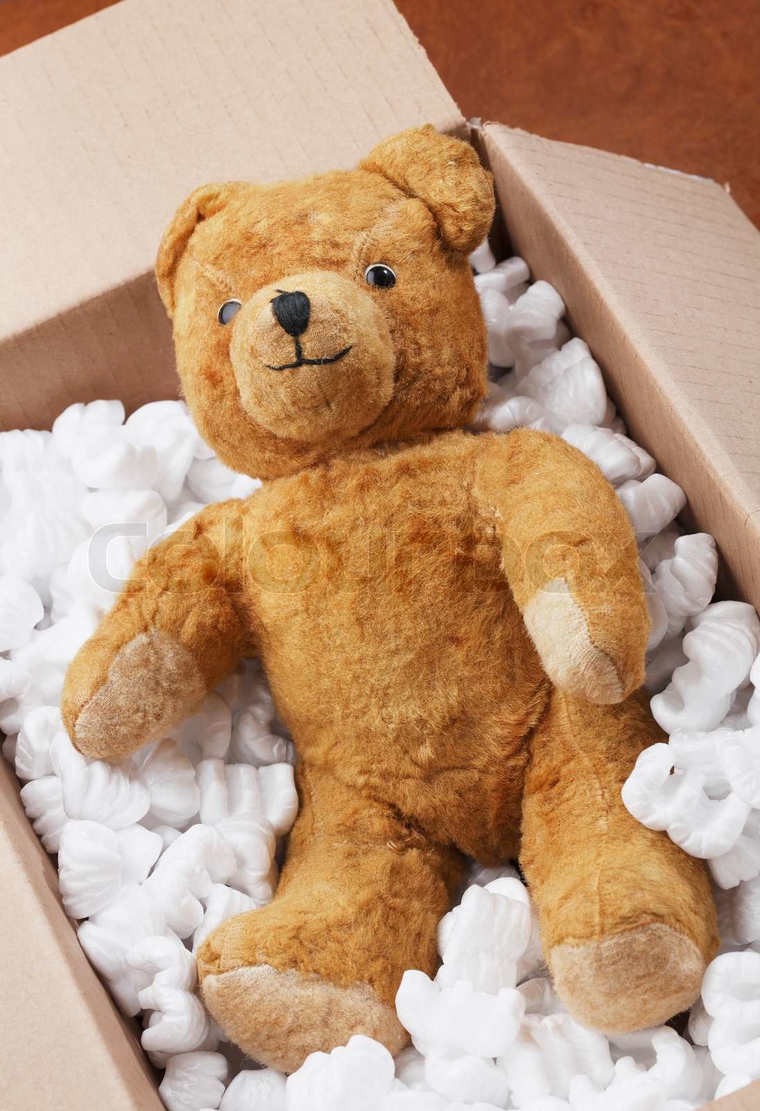Vintage generic teddy bear in a cardboard box | Stock image | Colourbox