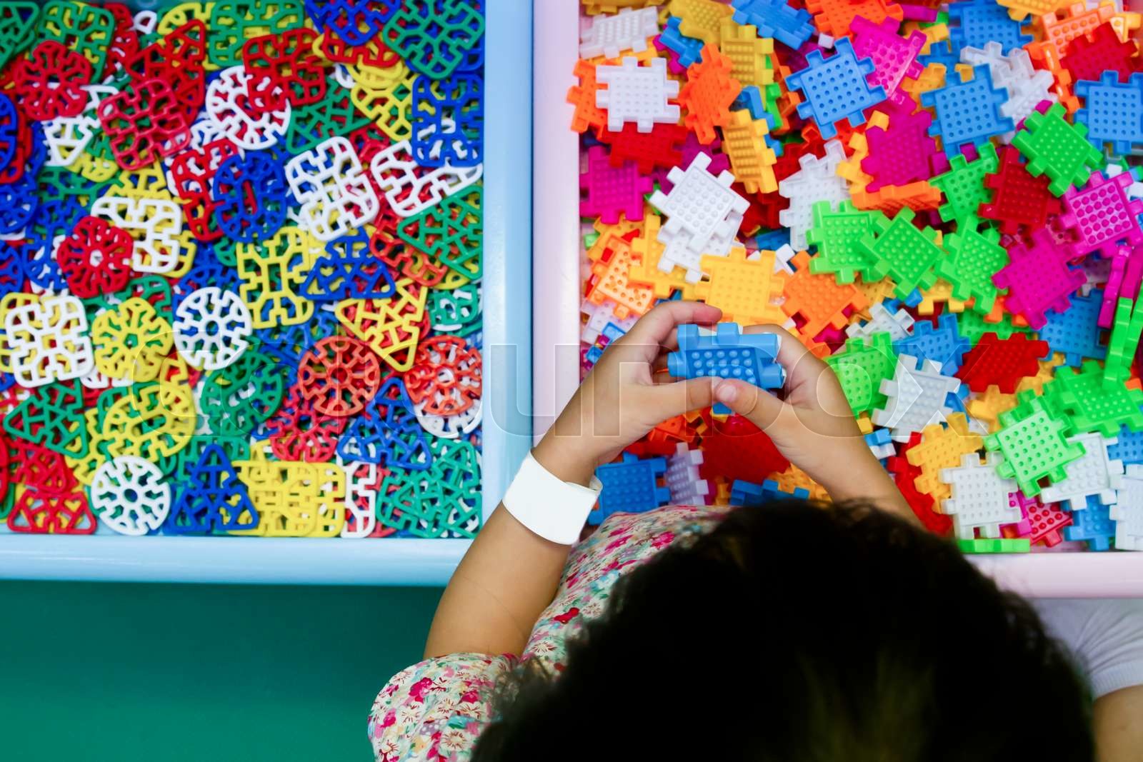 Chinese girl solving puzzle | Stock image | Colourbox