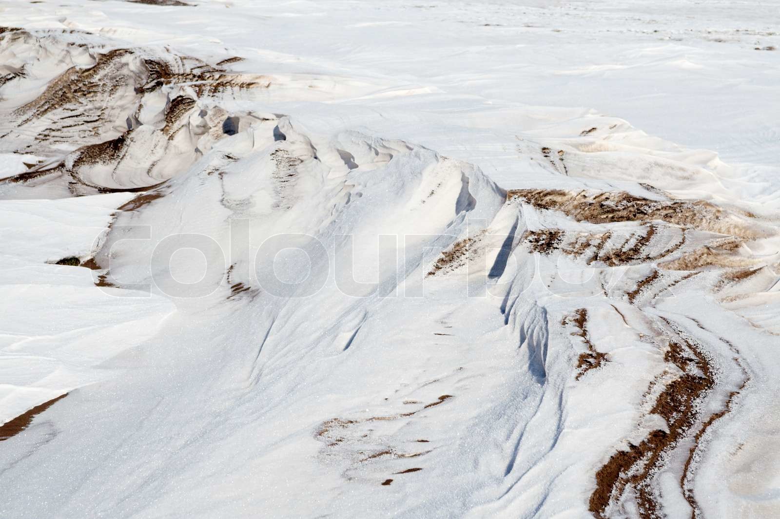 Sleet at a wind sticks to the ground, forming beautiful reliefs | Stock ...