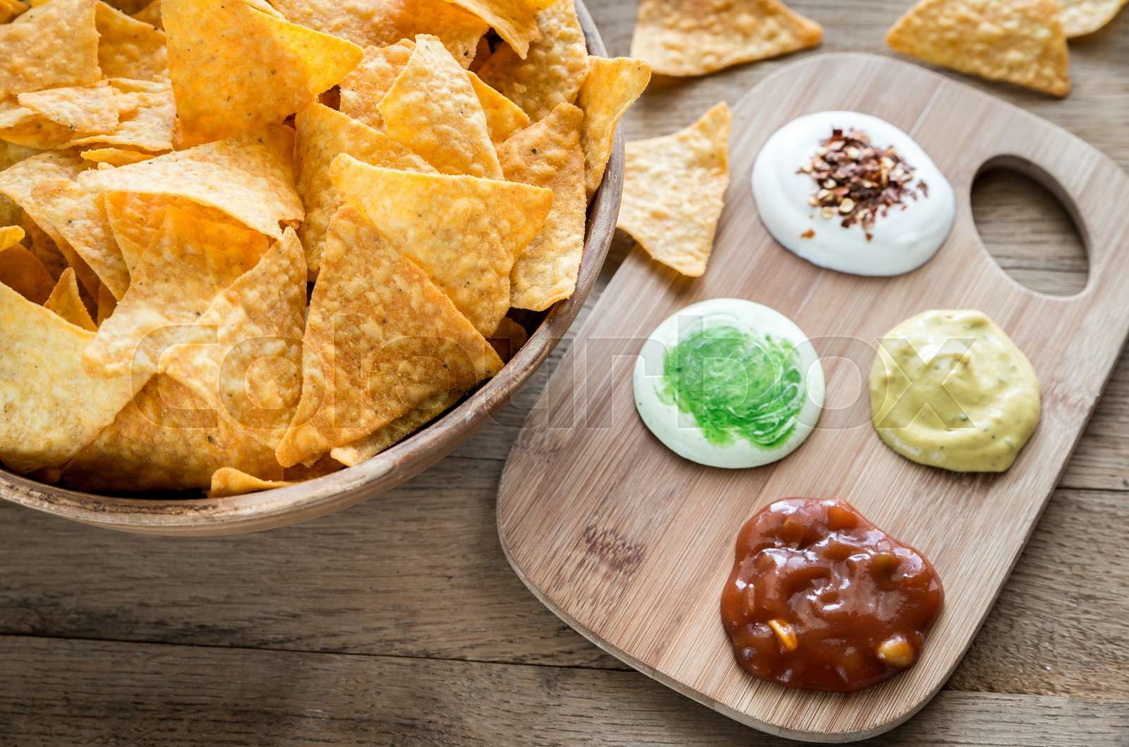 Cheese nachos with different types of sauce | Stock image | Colourbox
