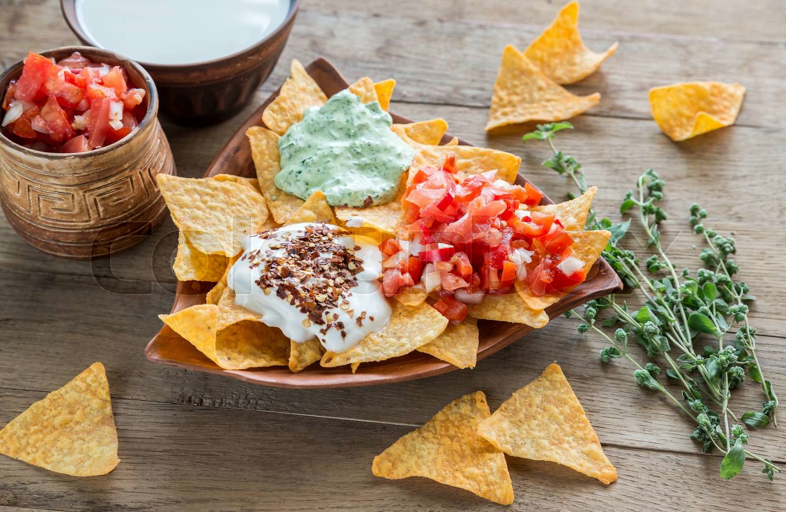 Cheese nachos with different types of sauce | Stock image | Colourbox