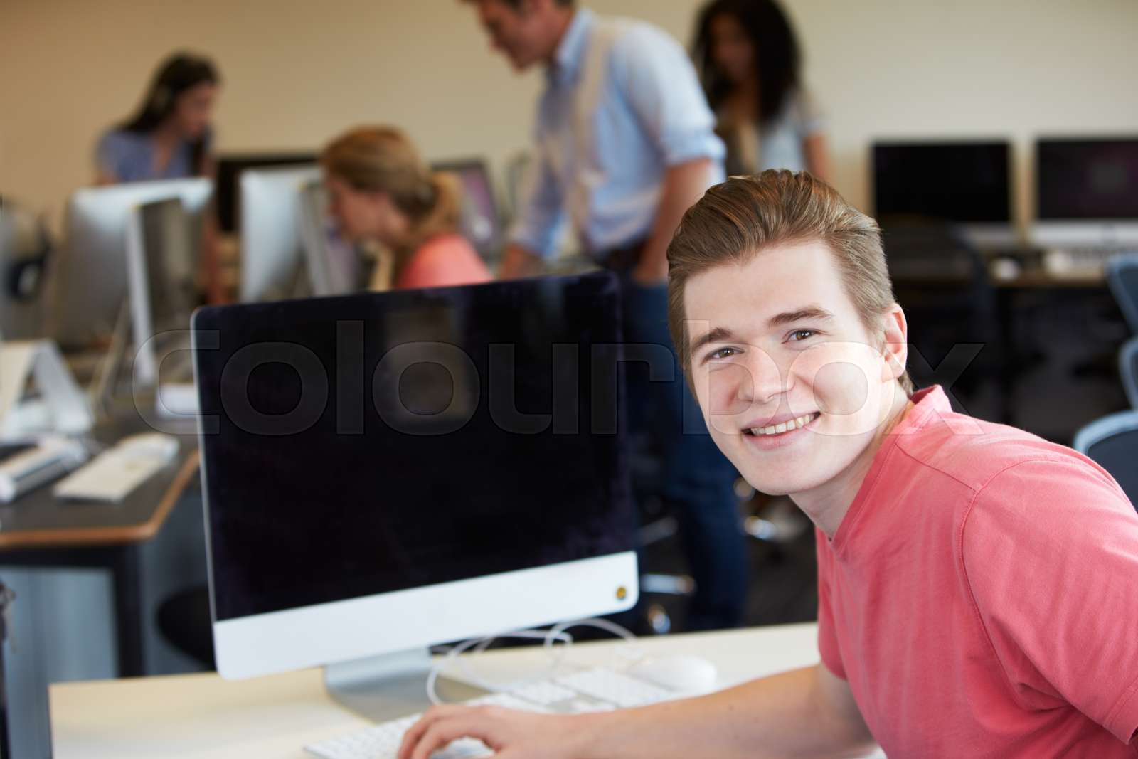 Male College Student Using Computer In Classroom | Stock image | Colourbox