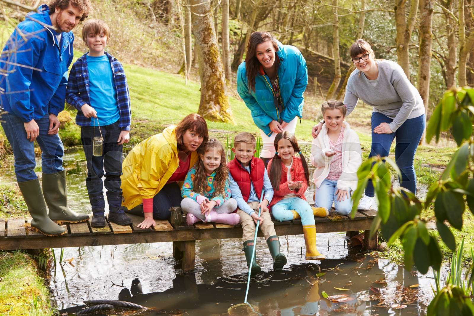 Adults With Children On Bridge At Outdoor Activity Centre | Stock image ...