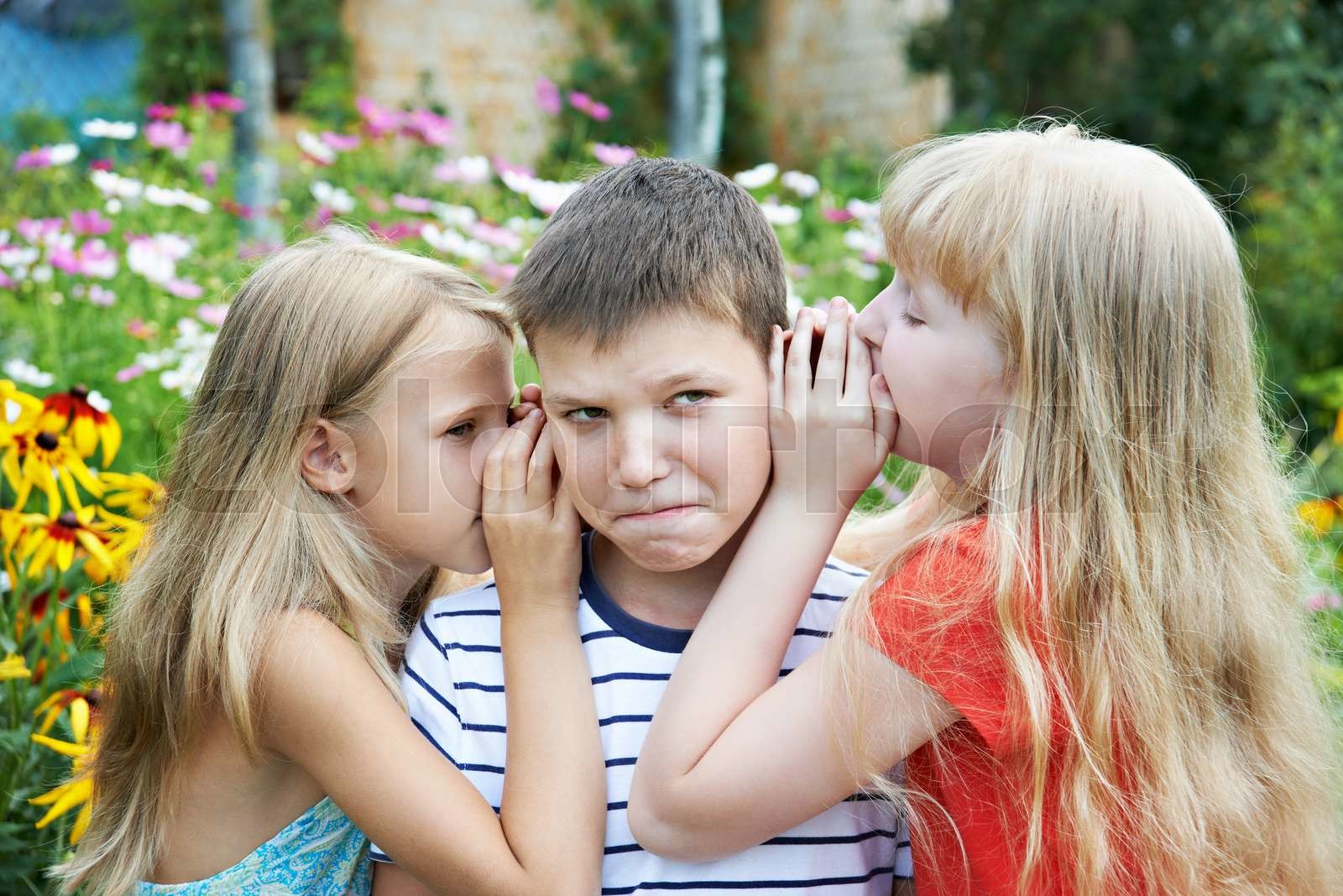Sister whispered to his brother | Stock image | Colourbox