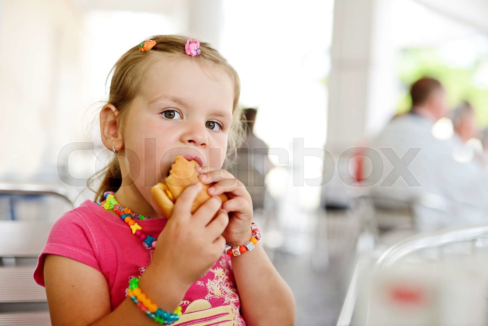 little girl with a hamburger | Stock image | Colourbox