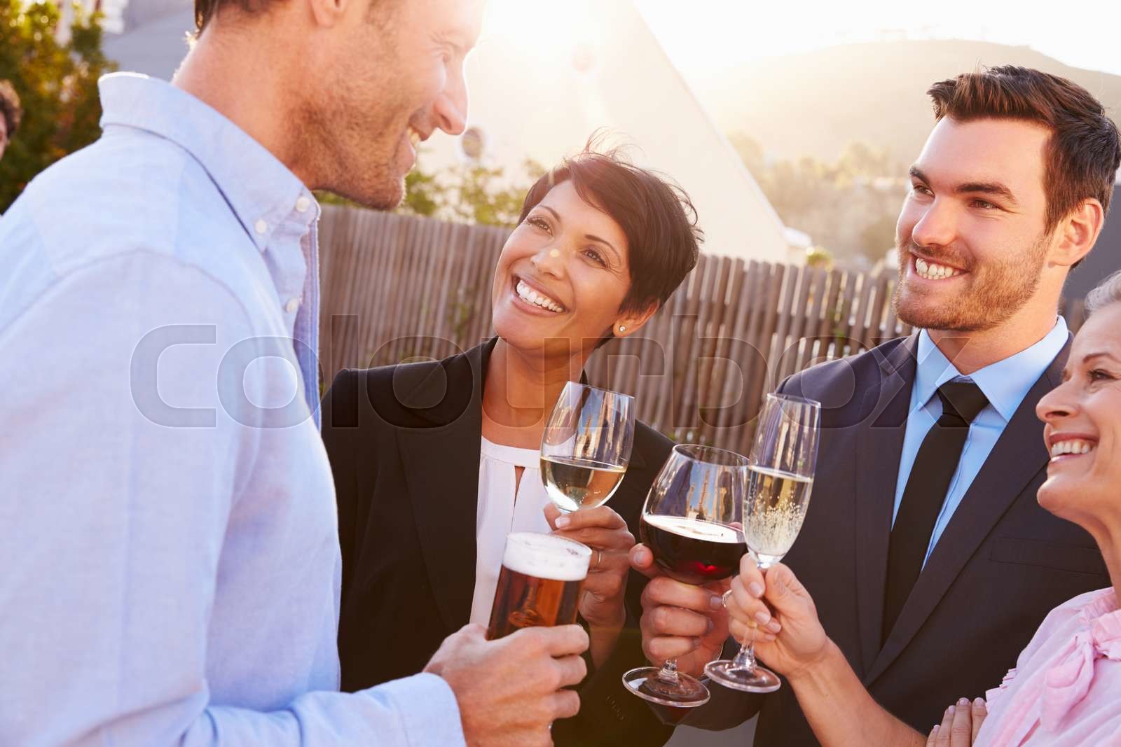 Colleagues drinking after work at a rooftop bar | Stock image | Colourbox