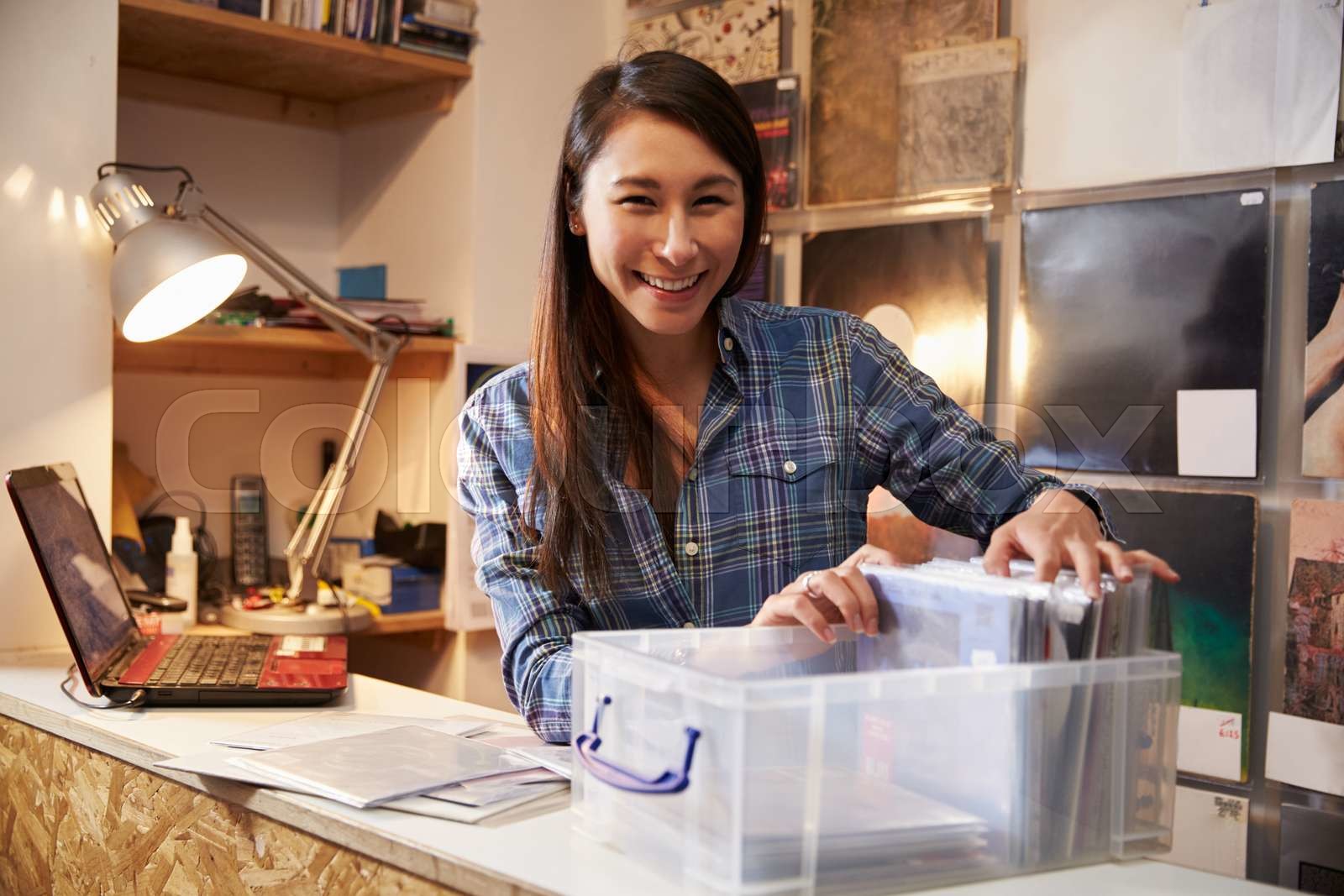 Young woman working behind the counter at a record shop | Stock image ...