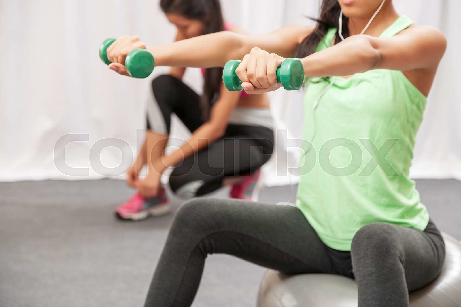 woman lift weight while sitting | Stock image | Colourbox
