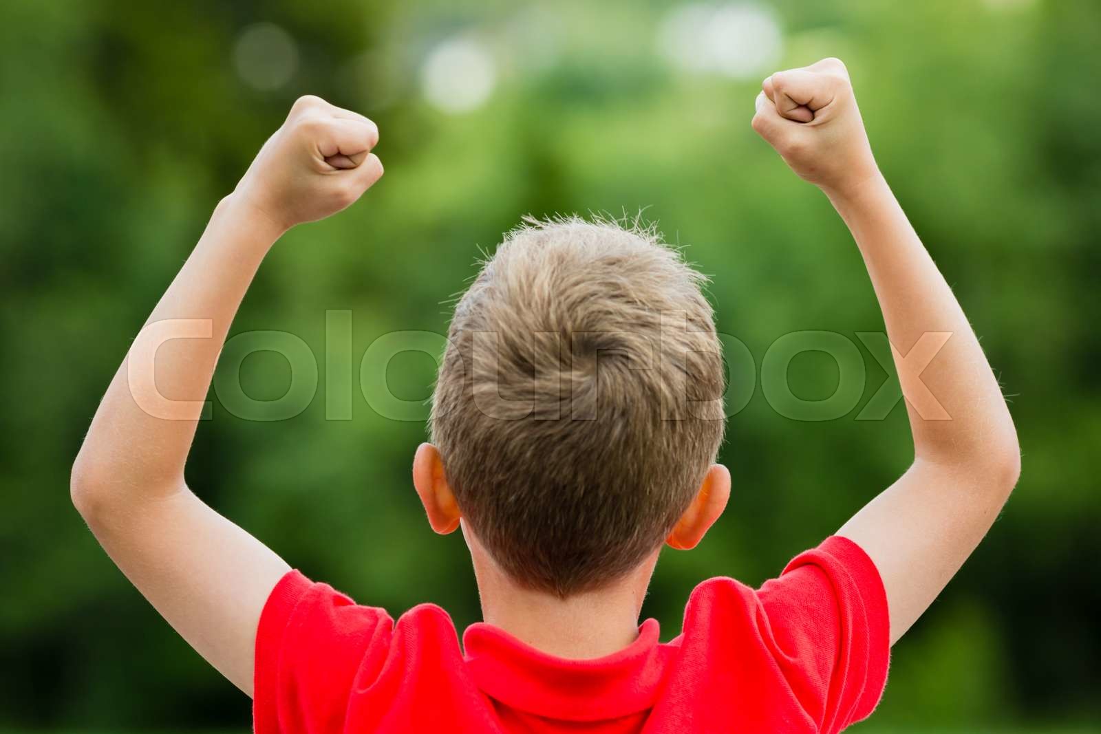 Child with raised fists | Stock image | Colourbox