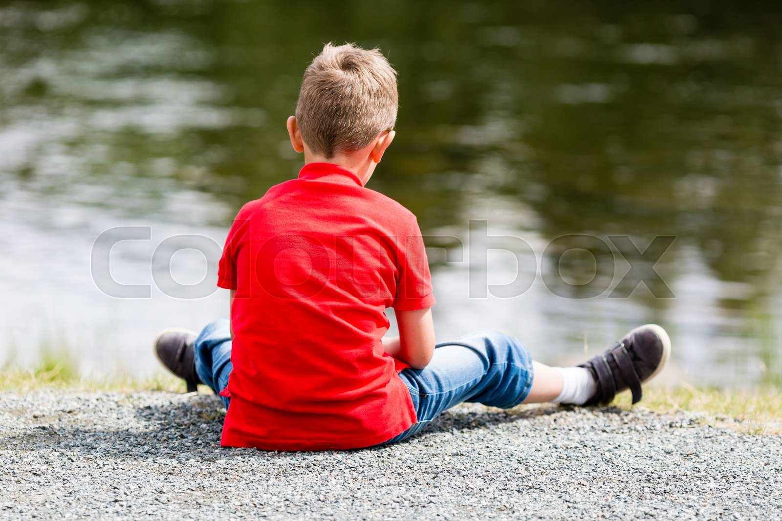 Lonely boy sitting down | Stock image | Colourbox