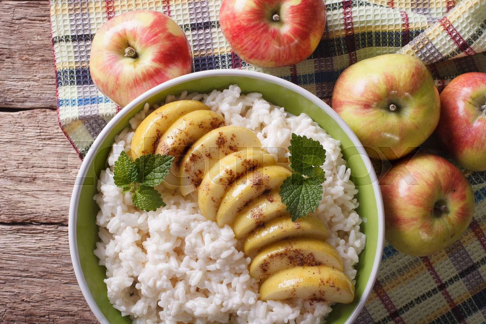 Rice with caramelized apples and fresh apples closeup. horizontal top ...