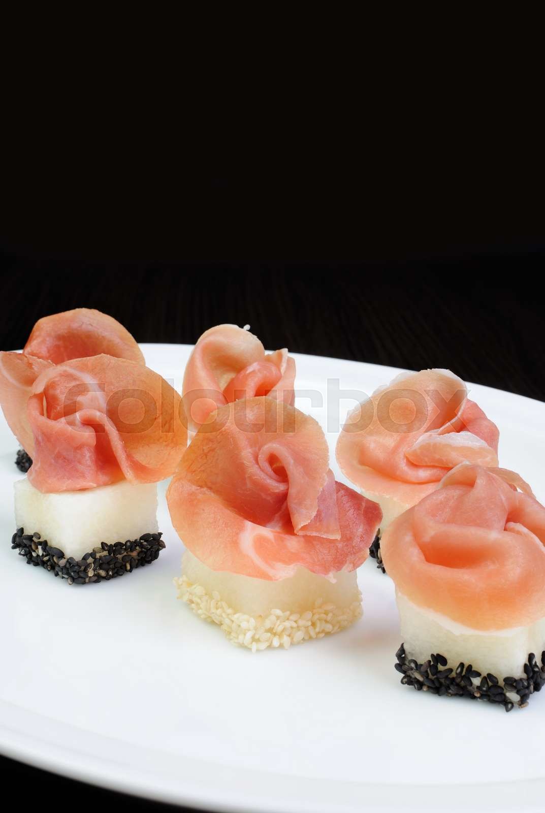 Canape melon in sesame with gammon | Stock image | Colourbox
